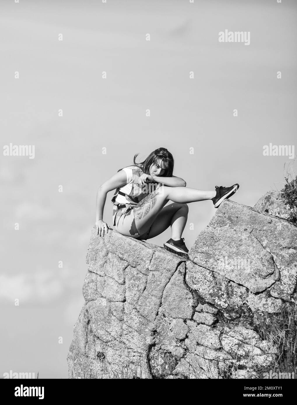 Enjoy the view. Tourist hiker girl relaxing edge cliff. Dangerous relax ...