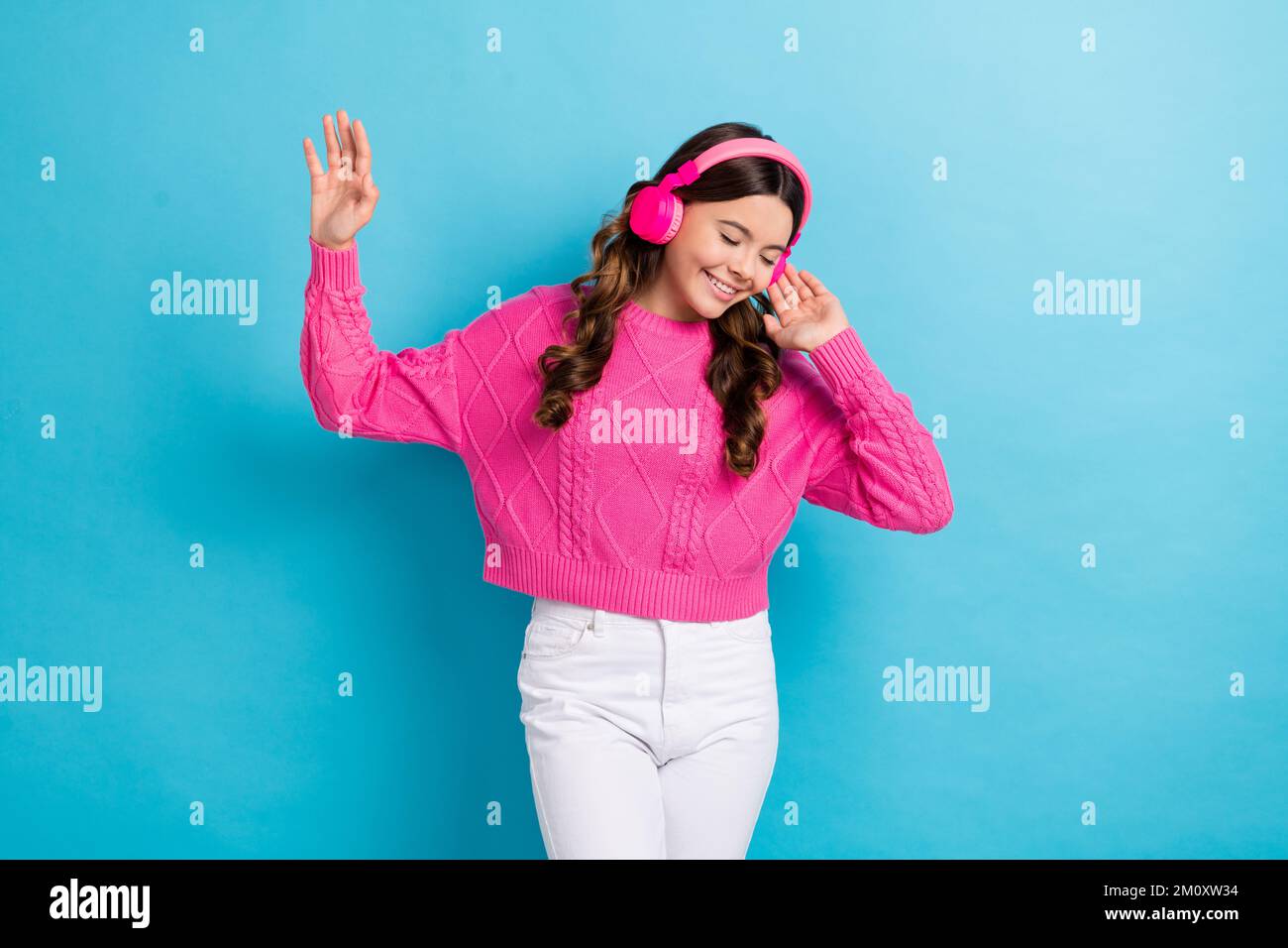 Photo of young curly brown hair teenager school girl wear pink knit ...