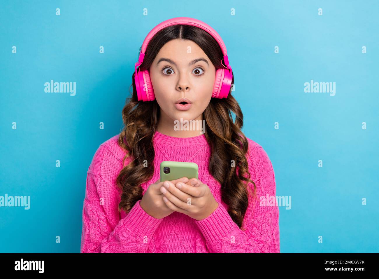 Photo of impressed girl dressed knit pullover earphones listening music ...