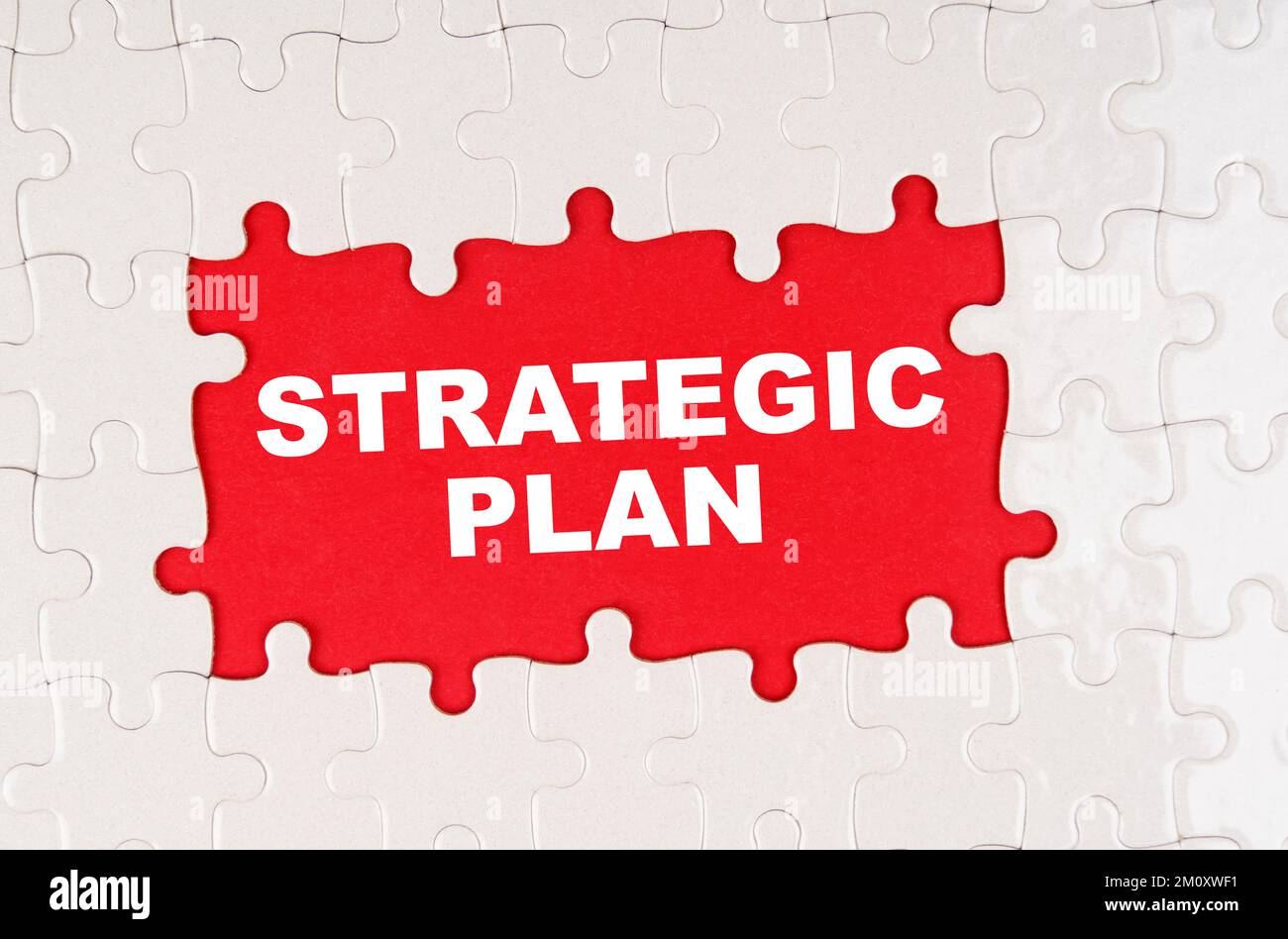 Business and finance concept. In the middle of the puzzles on a red ...