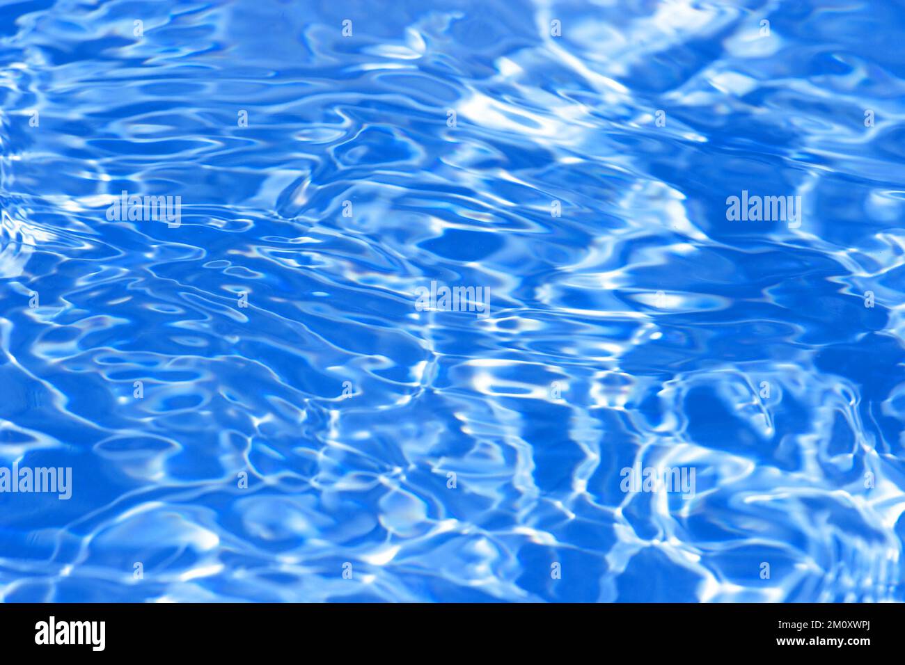 Sunlight shining on a blue swimming pool Stock Photo - Alamy