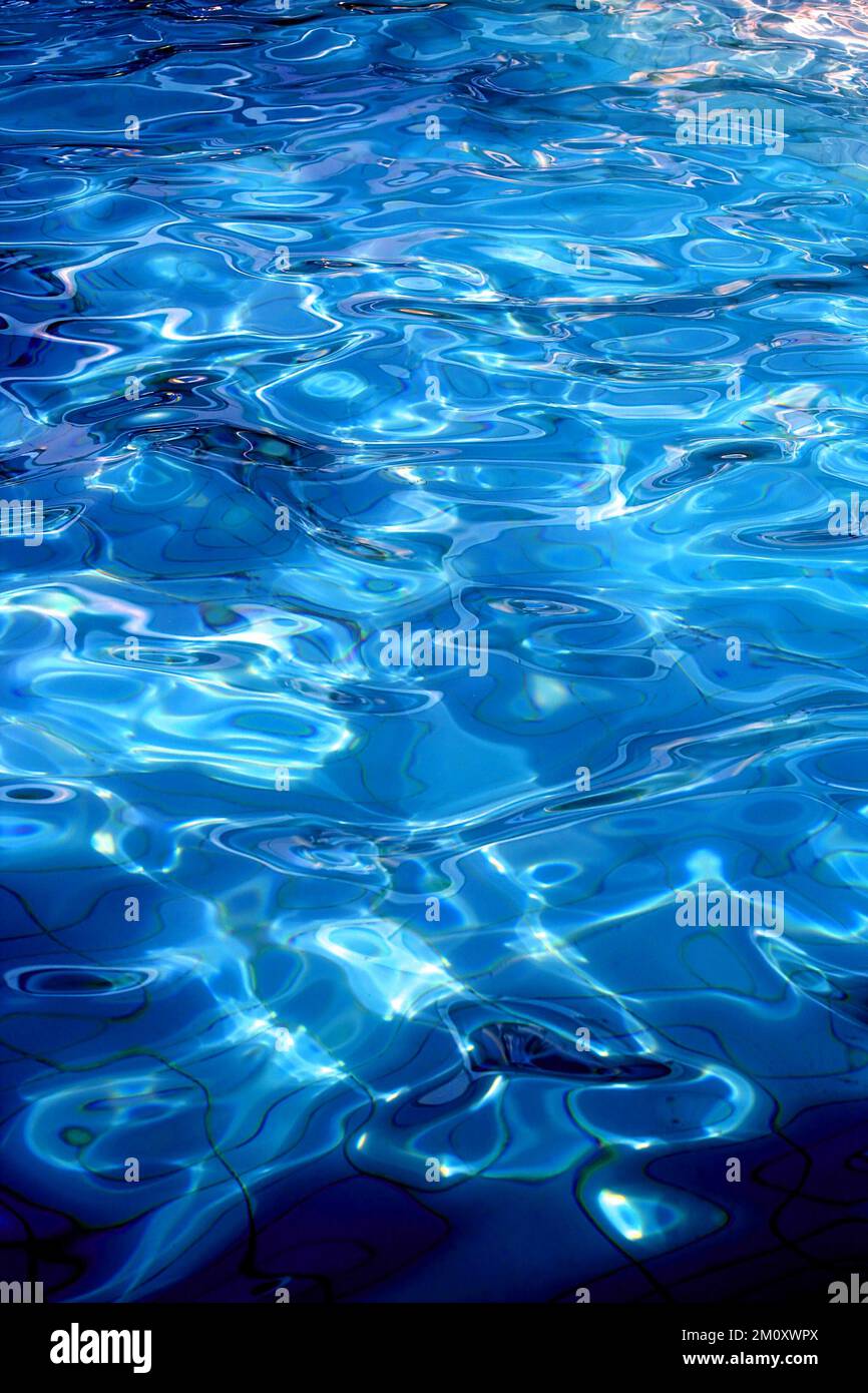 Sunlight shining on a blue swimming pool Stock Photo - Alamy