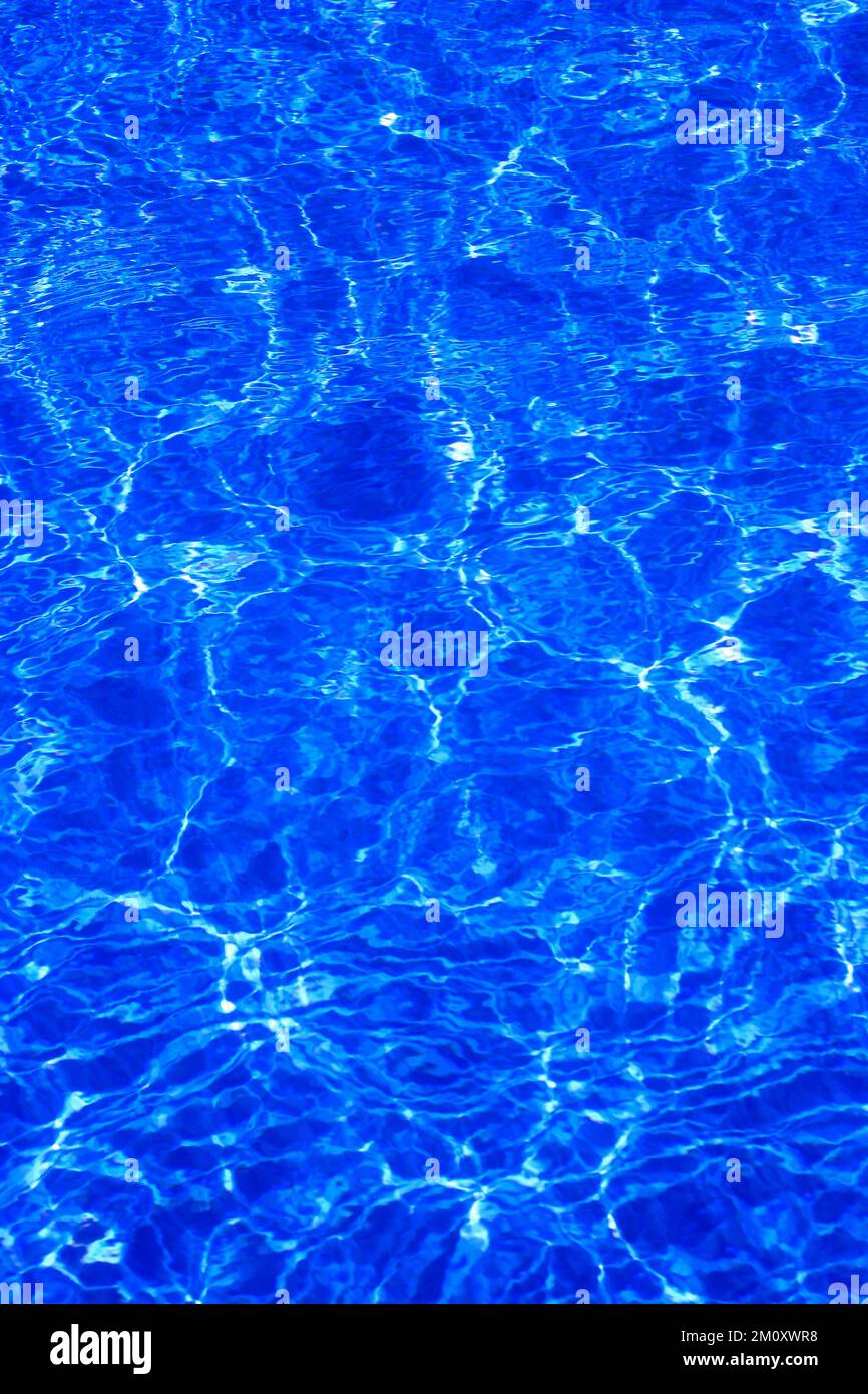Sunlight shining on a blue swimming pool Stock Photo - Alamy