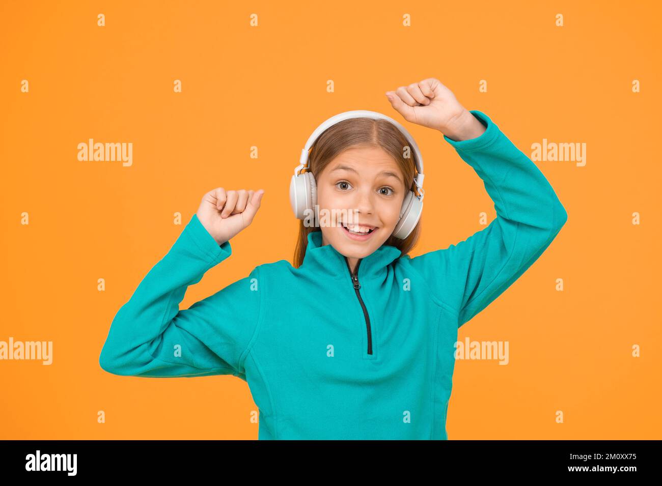 The song is cool. Cute small child listen to song on yellow background ...