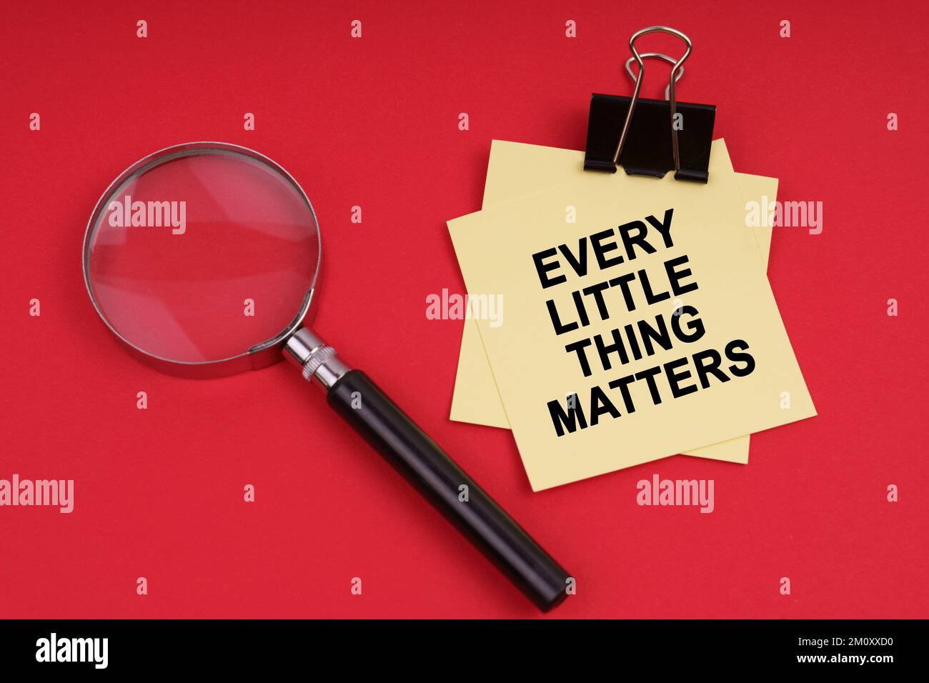 Business and Economics. On a red background, a magnifying glass and a ...