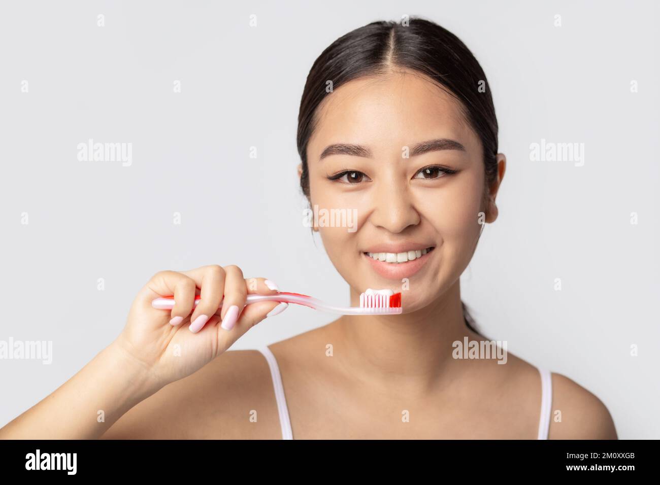 Smiling Woman With Smile With White Teeth Holding Toothbrush With