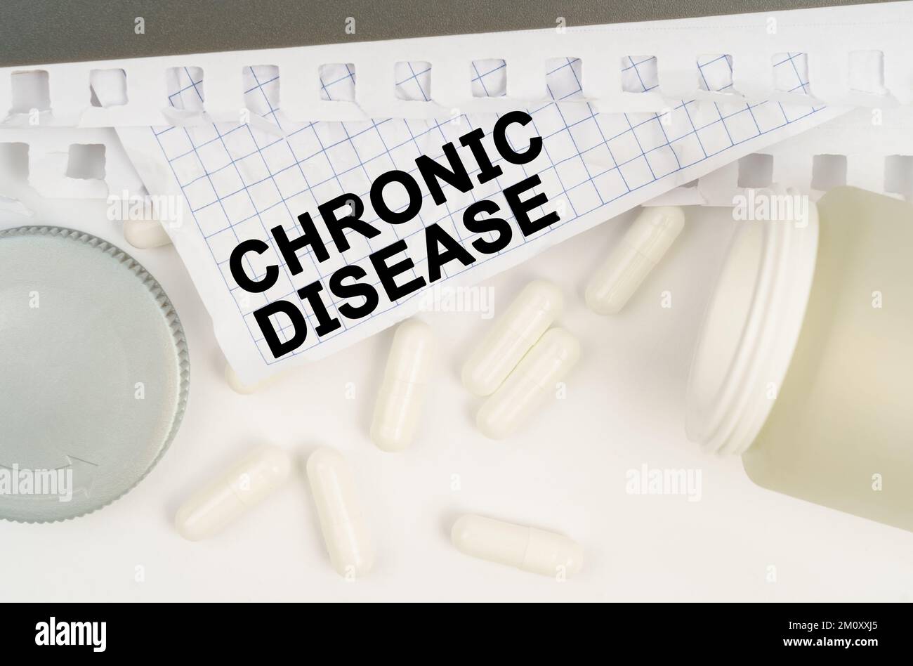 Medicine and health concept. On the table is an open jar of pills and a ...