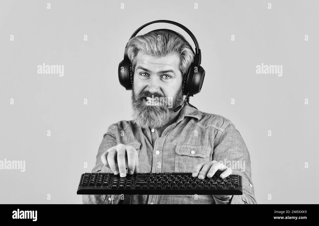 His Creative Office. bearded man listen headphones and keyboard ...