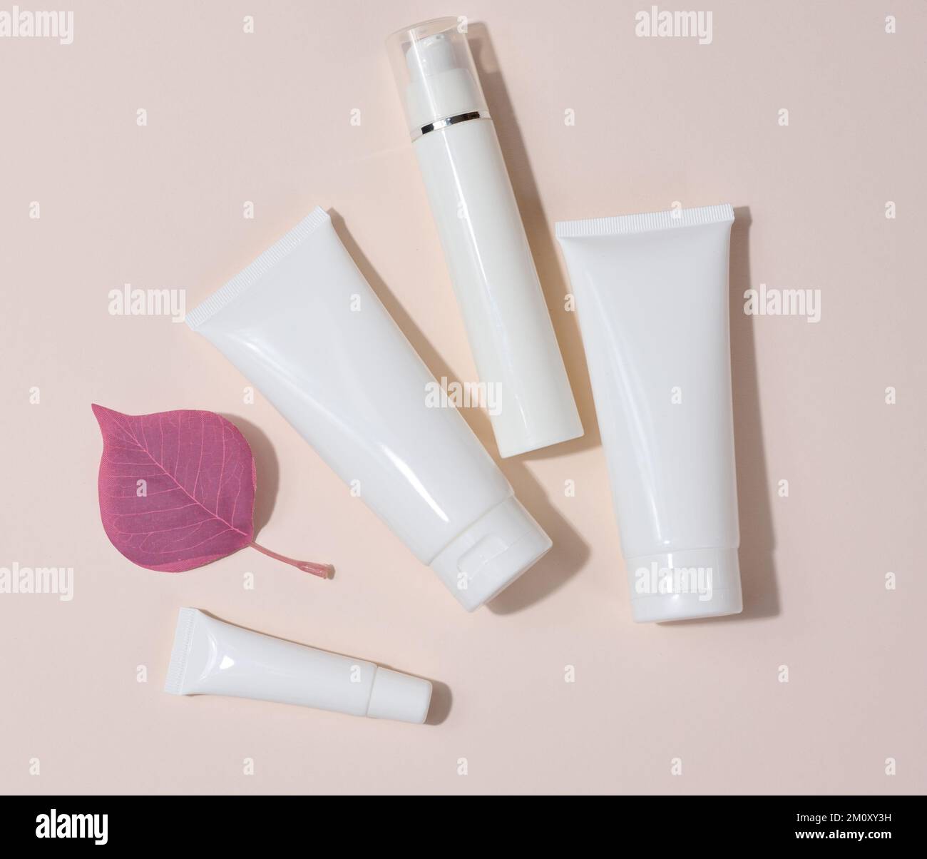 White plastic tubes, jars and other form of packaging for cosmetics on ...