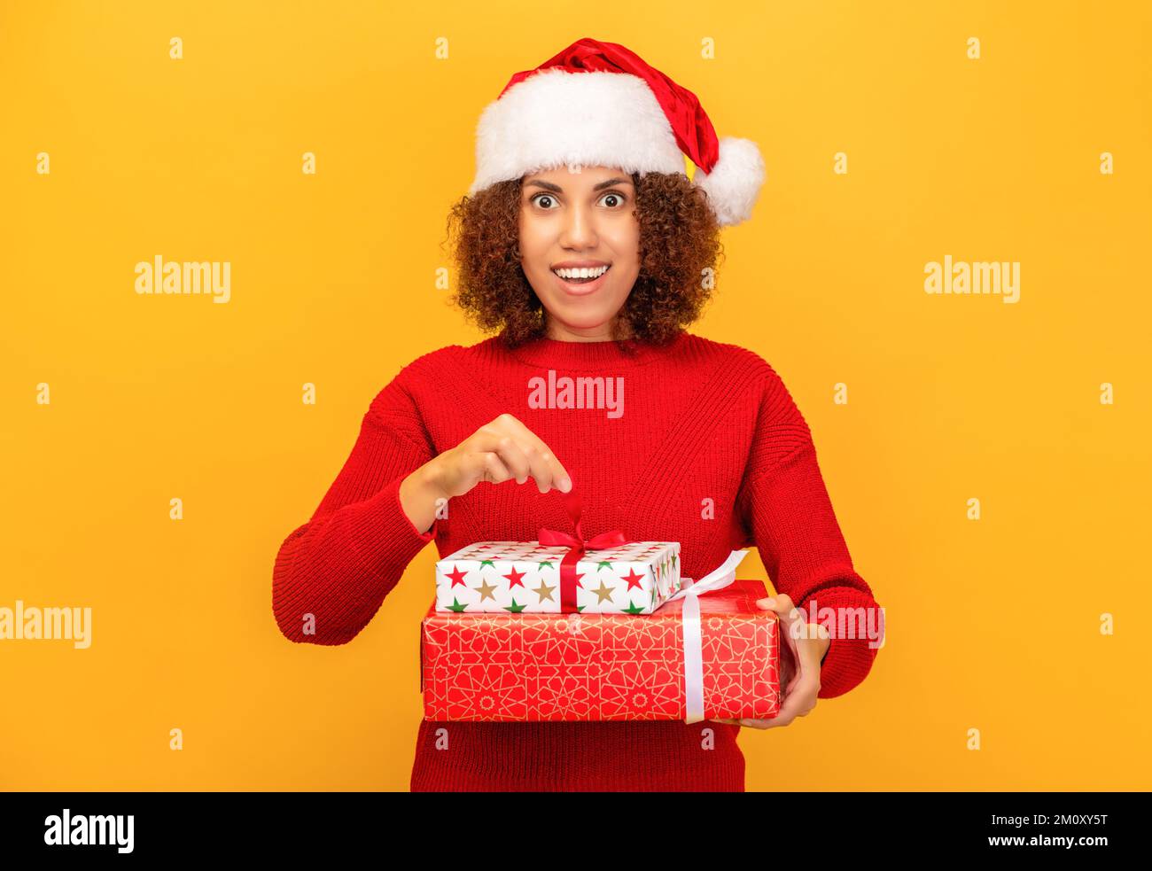 Pleasantly excited happy woman holds in hands christmas gift. woman in ...