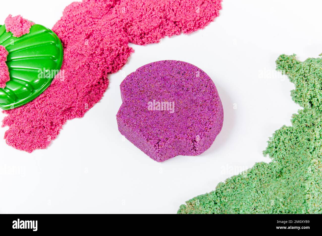 Colorful kinetic sand, plastic molds for sand. Child sculpts and plays ...
