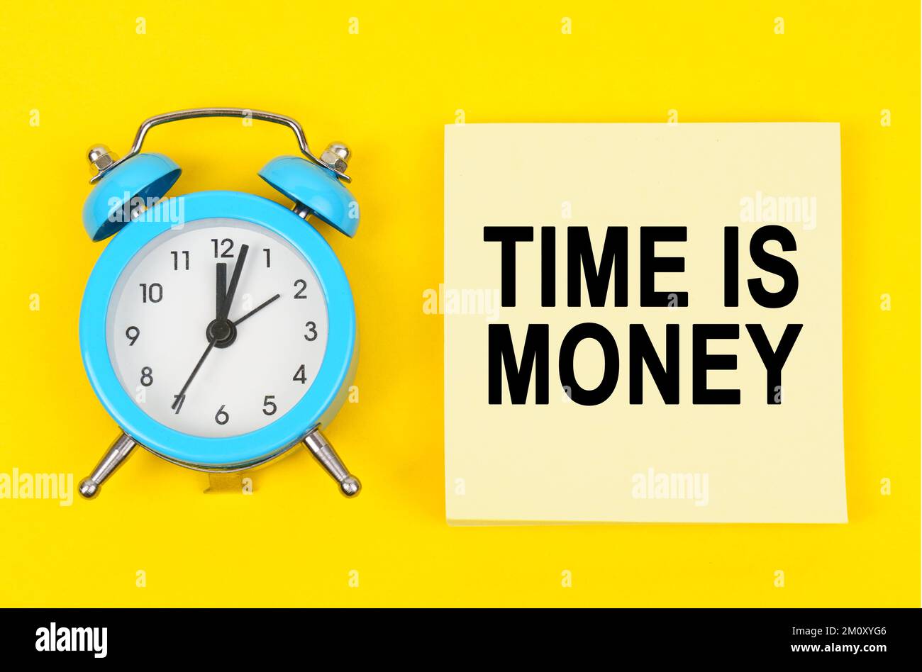 Business and finance concept. On a yellow background lie a clock and a ...