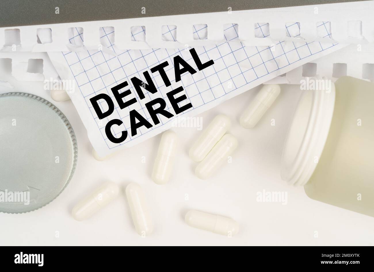 Medicine and health concept. On the table is an open jar of pills and a ...