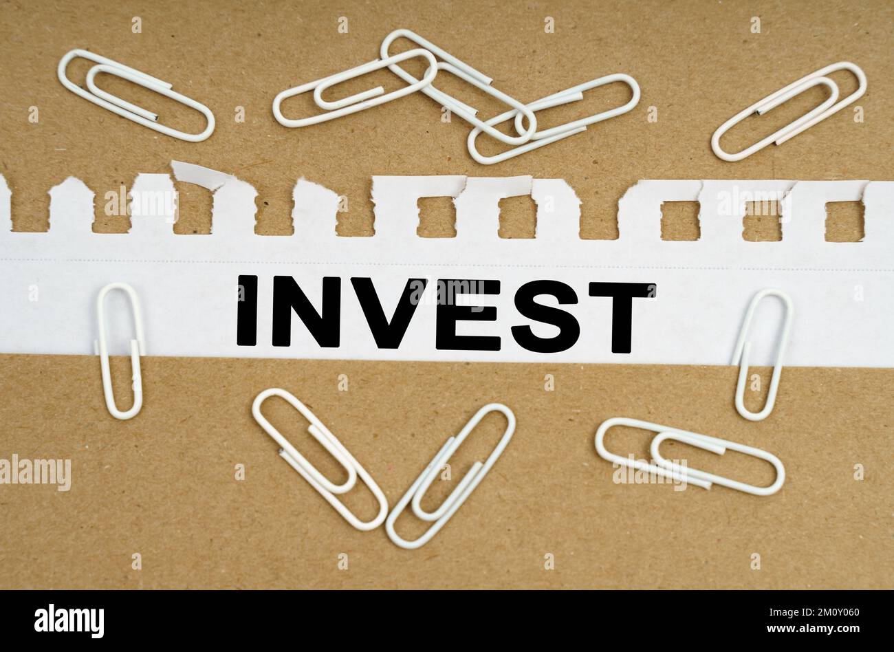 Business concept. On cardboard, white paper clips and a sheet from a ...