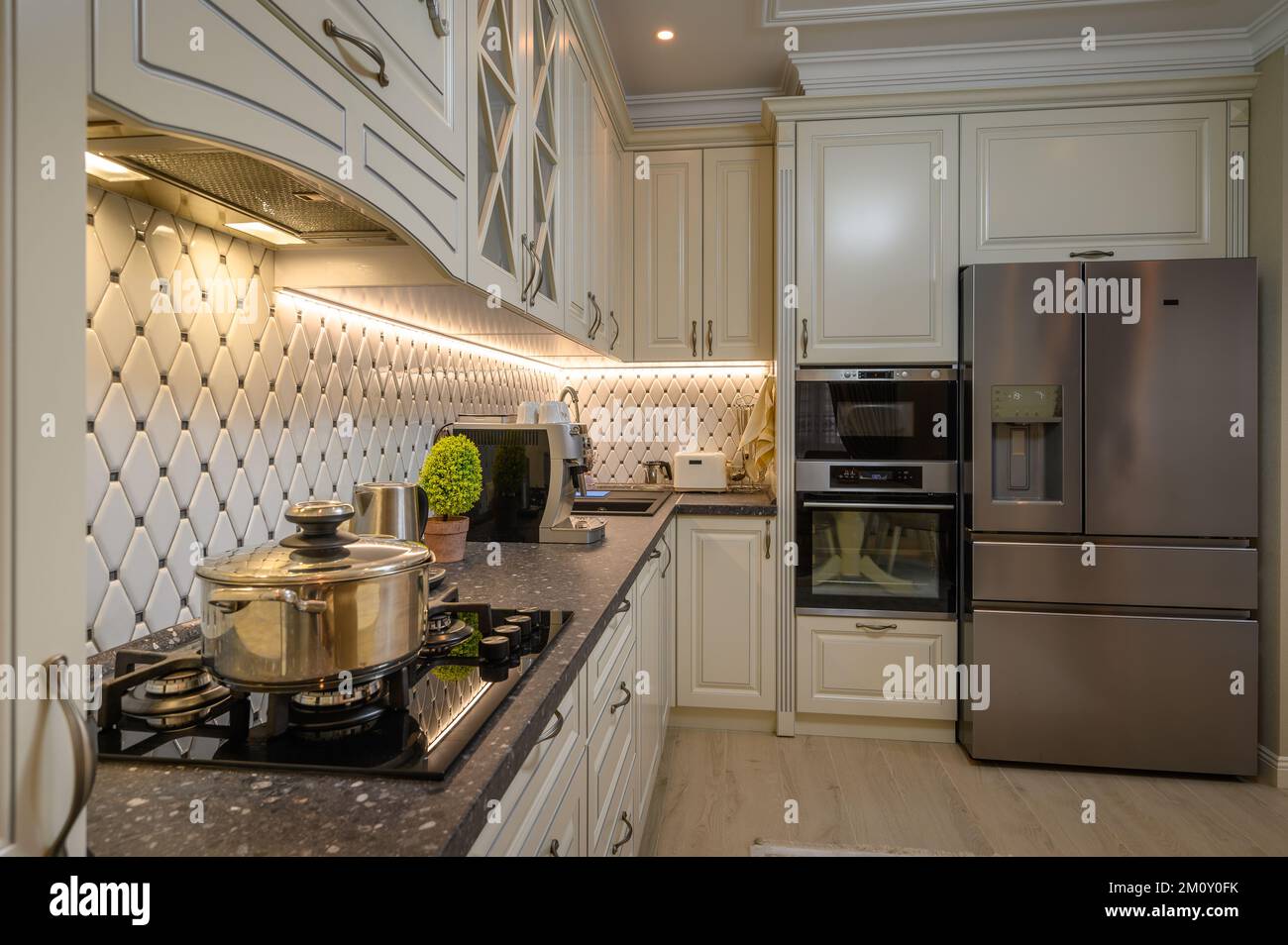 Open-concept kitchen with a beige color scheme and classic design ...
