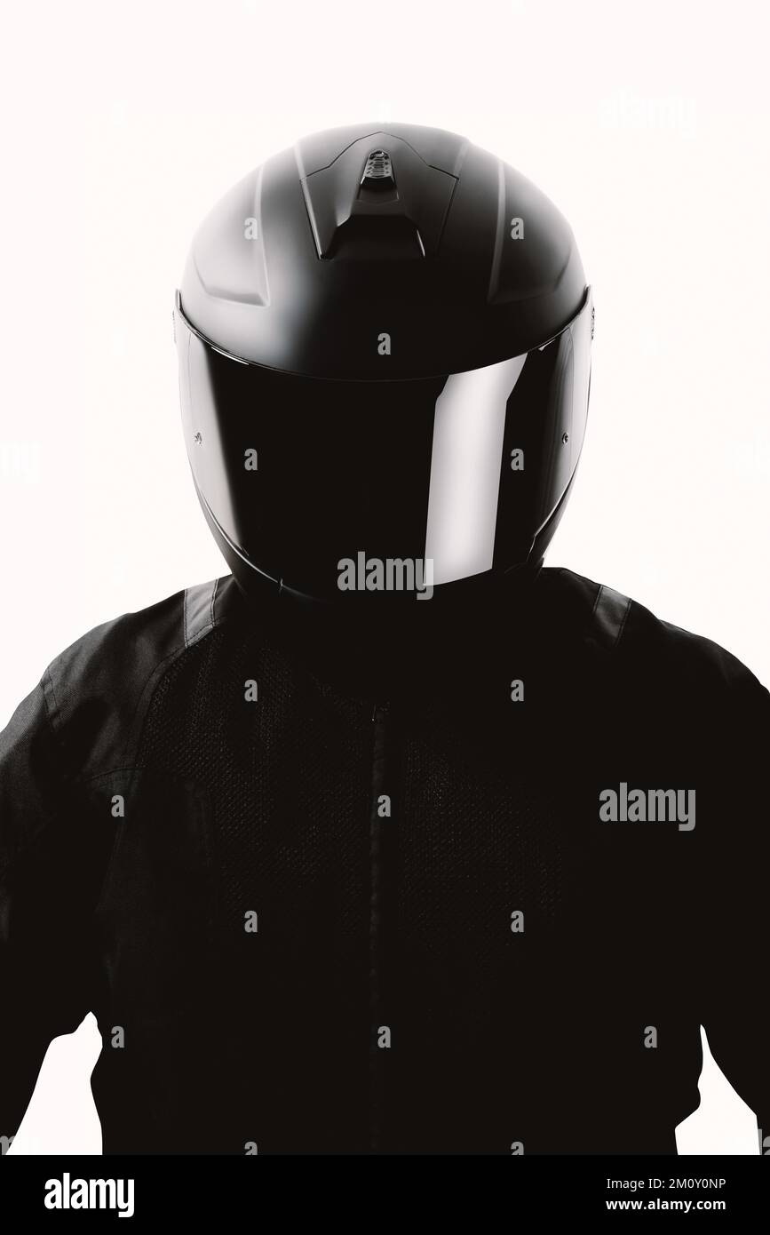 Portrait of a motorcycle rider posing with a black helmet on a white ...