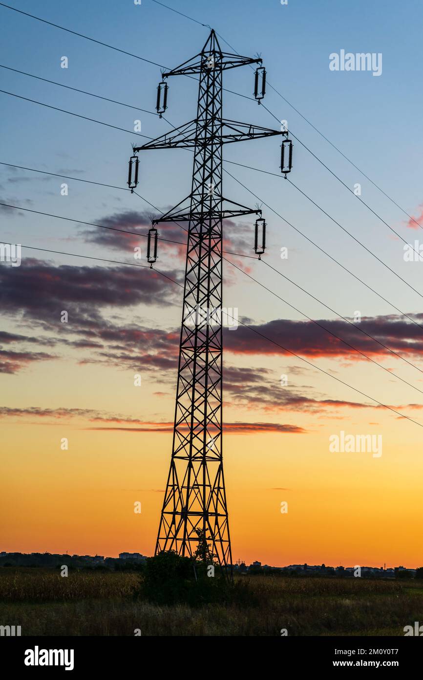 A vertical view of an overhead electric pole with power supply lines at ...