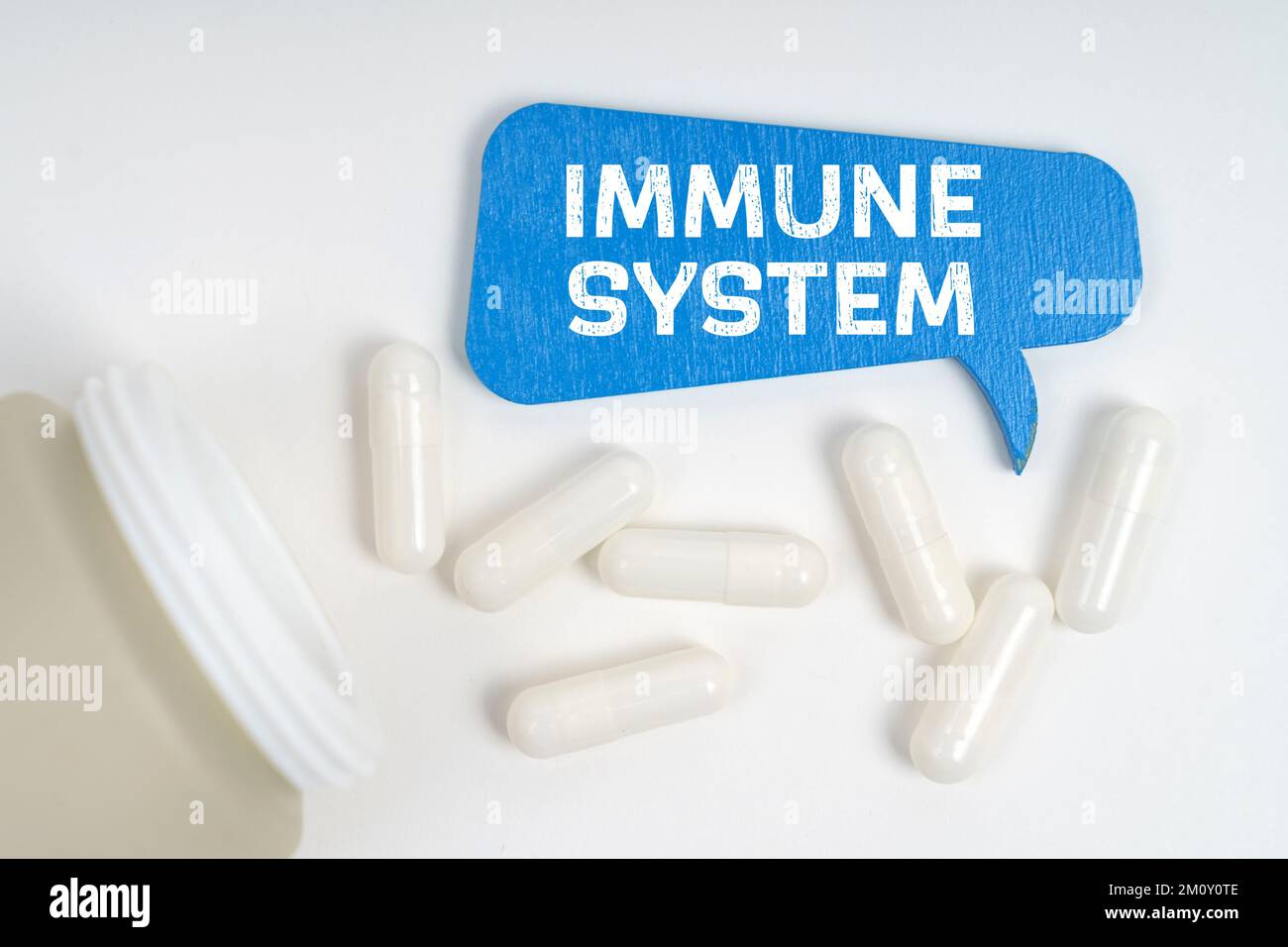 Medicine and health concept. On the table are pills and a blue sign ...