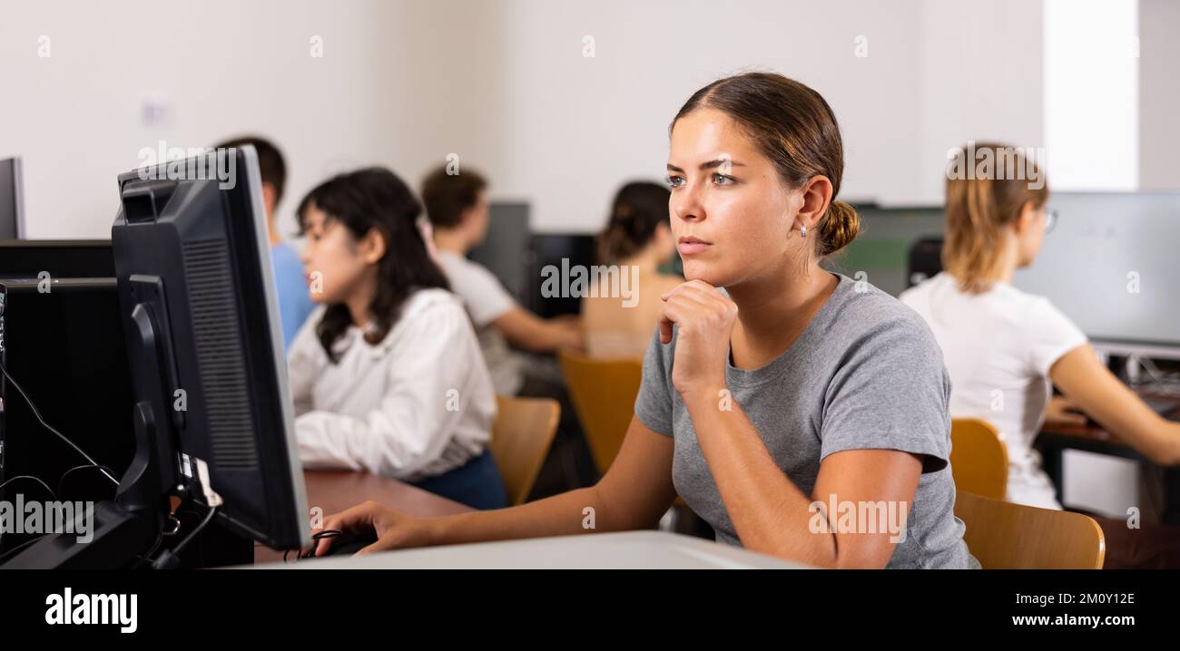 Young woman using computer in classroom Stock Photo - Alamy