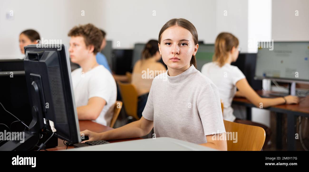 Concentrated female student using PC and studying computer science in ...