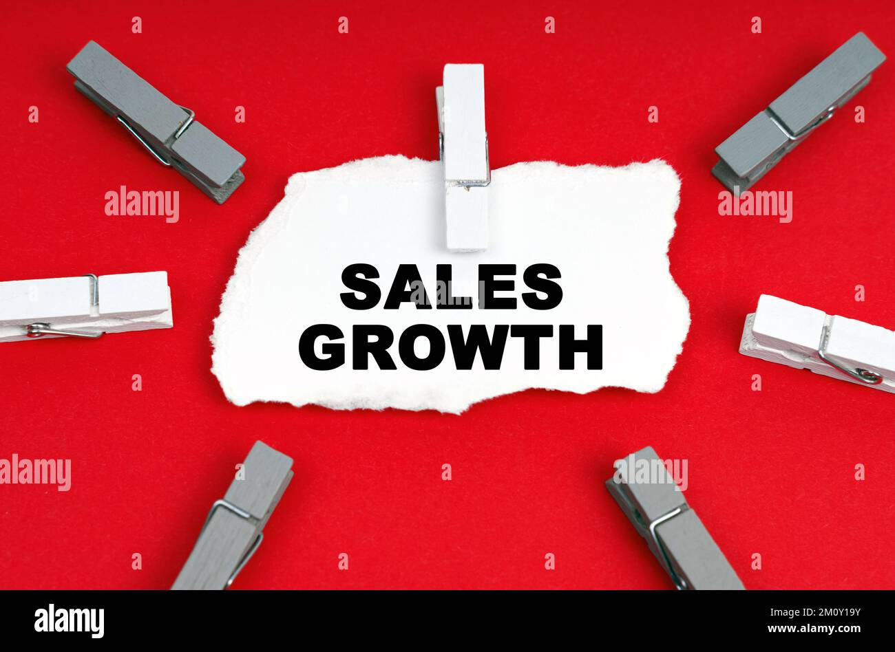 Business and Economics. On a red background, there are clothespins and ...