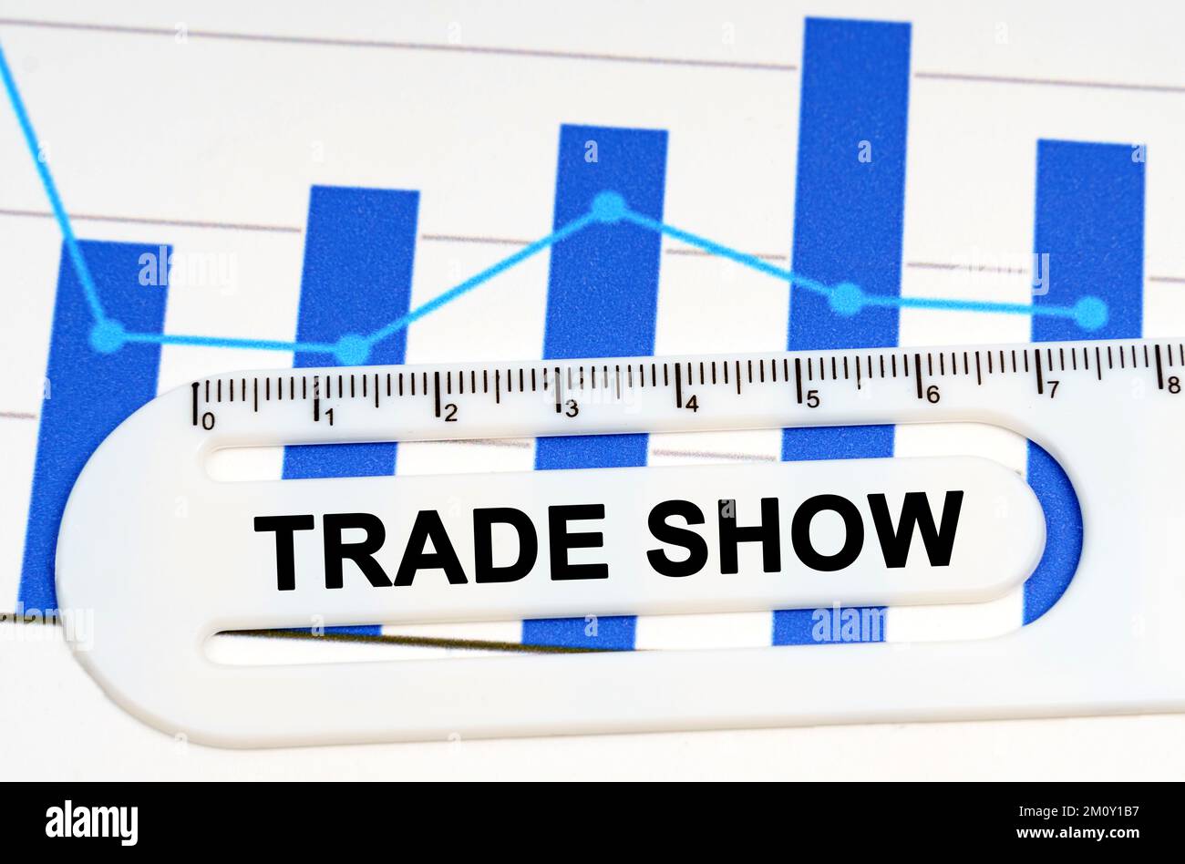 Economy concept. On the sheet with graphs there is a white ruler with ...