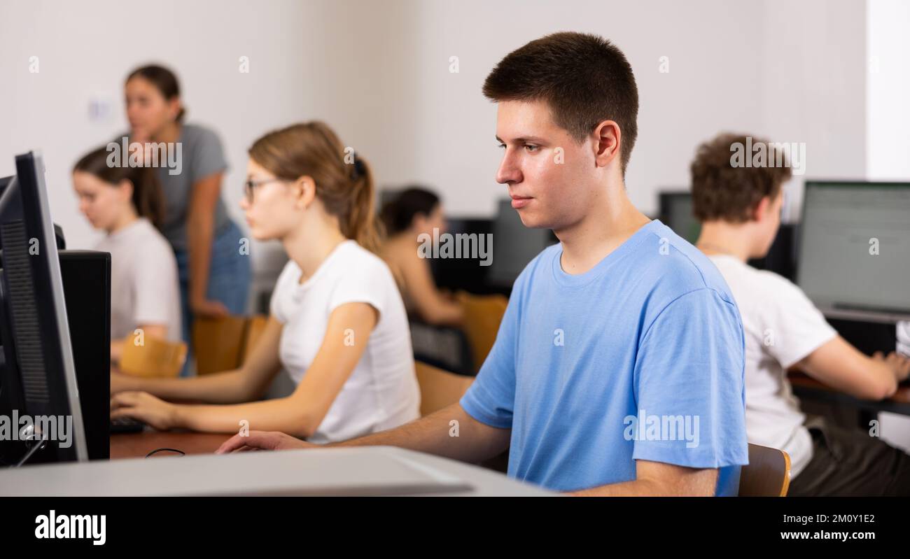 Teenage boy learning to use personal computer during lesson Stock Photo ...