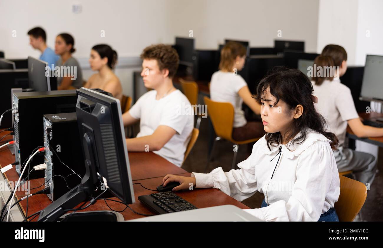 Smart Asian female teenager learning computer science while she is ...