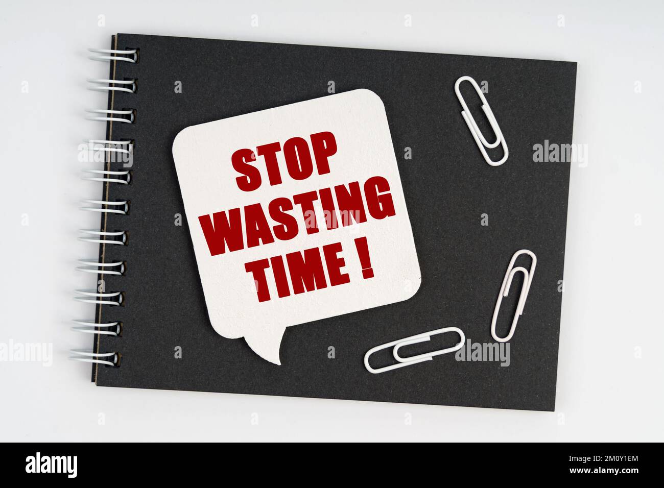 Business concept. On the notebook are white paper clips and a sign with ...