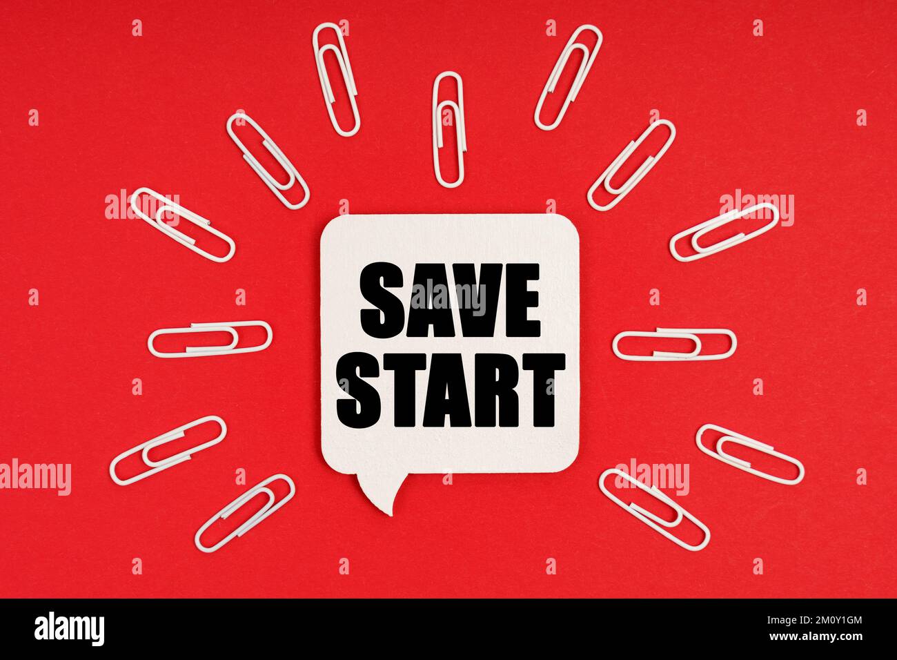 Business and finance concept. On a red background are paper clips and a ...