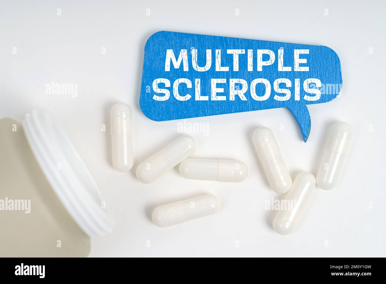 Medicine and health concept. On the table are pills and a blue sign ...