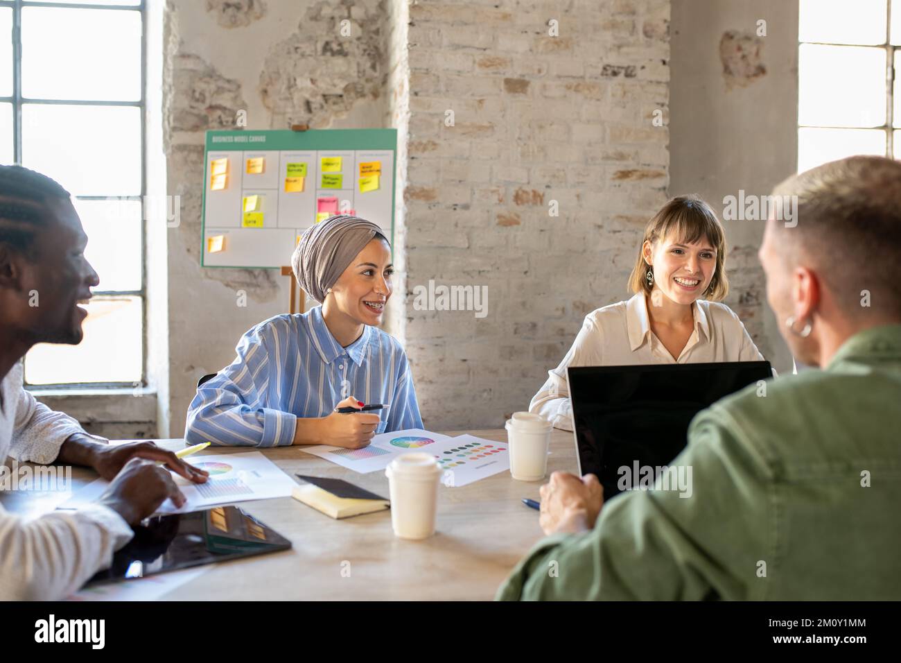 Young multiracial team of creative colleagues working in a open space ...