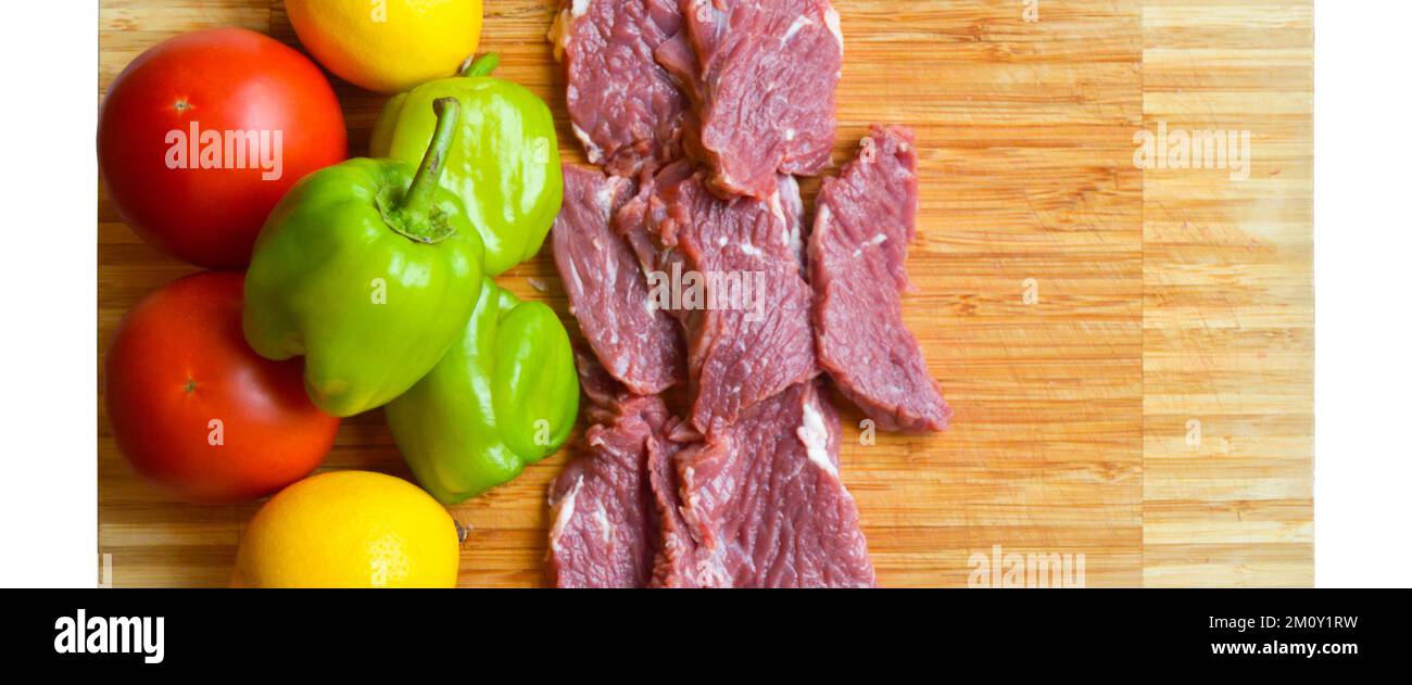Clean red raw cow meat beef, and very fresh vegetables on bamboo ...