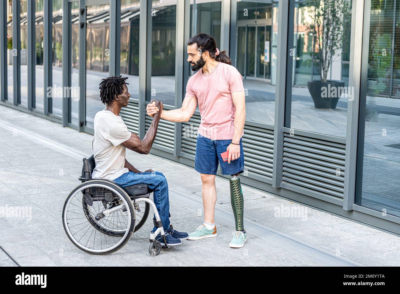 Multiracial people greeting each other, happy friends with disability ...