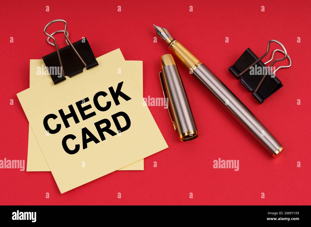 Business concept. On a red background, a pen and stickers with the ...