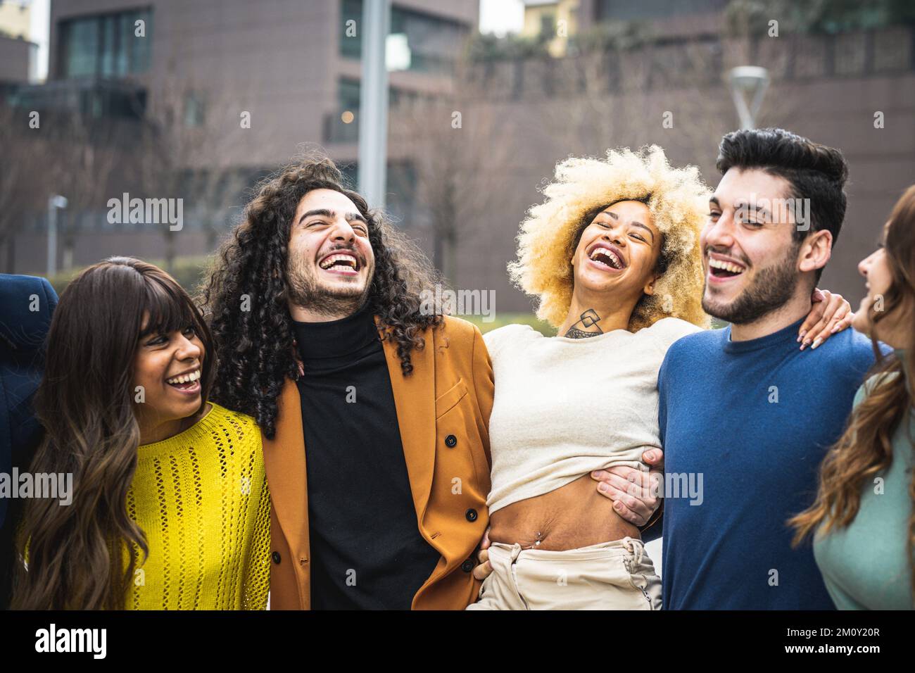 multicultural group of friends walking and having fun together ...