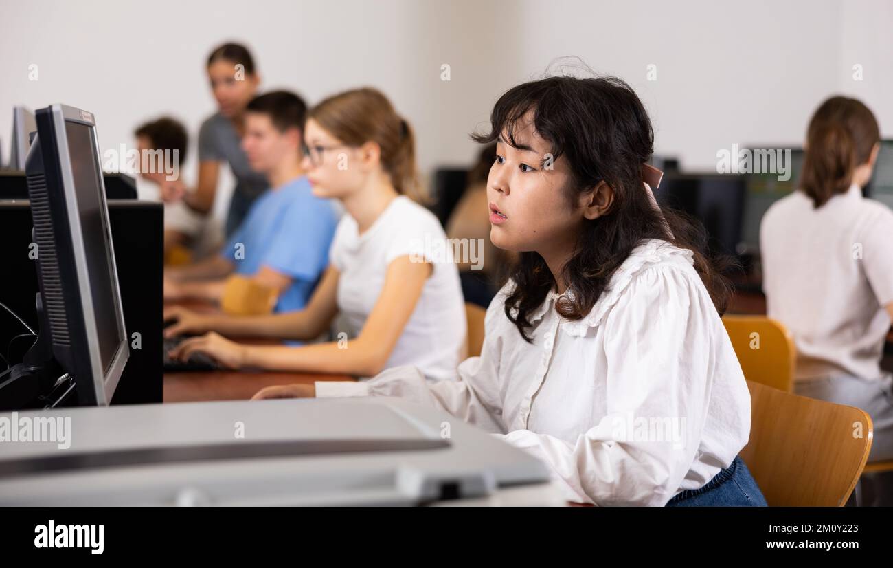 Teenager girl using PC during computer science lesson Stock Photo - Alamy