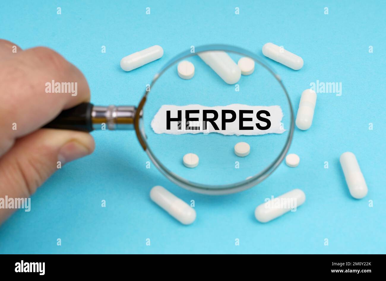 Medicine and health concept. A man looks through a magnifying glass at ...