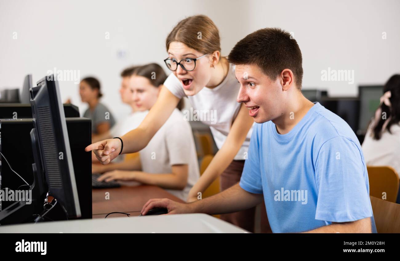 Happy students enjoying the end of project while studying computer ...