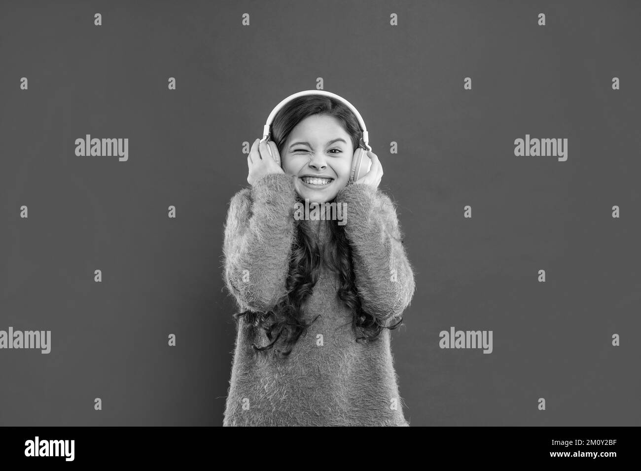 listening audio book. glad child listen music in headphones. kid wear ...