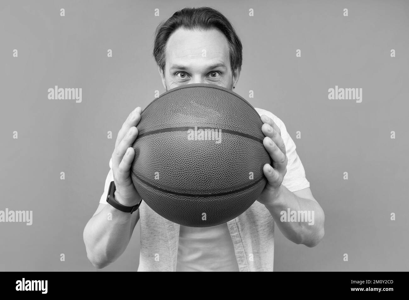 man behind basketball ball on grey background, sport game Stock Photo ...
