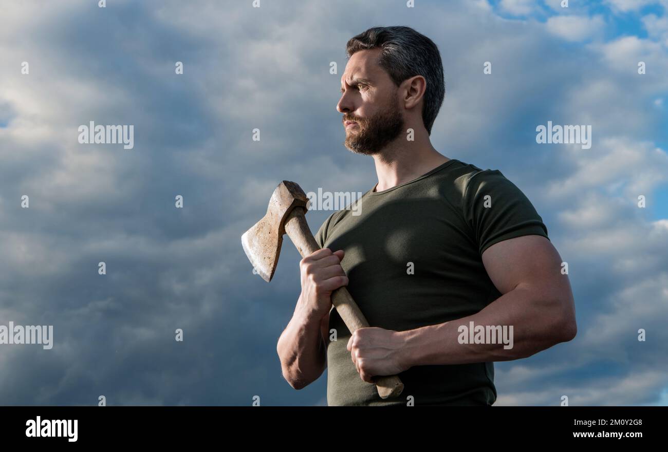 strong man with axe. muscular man hold ax. brutal man on sky background ...