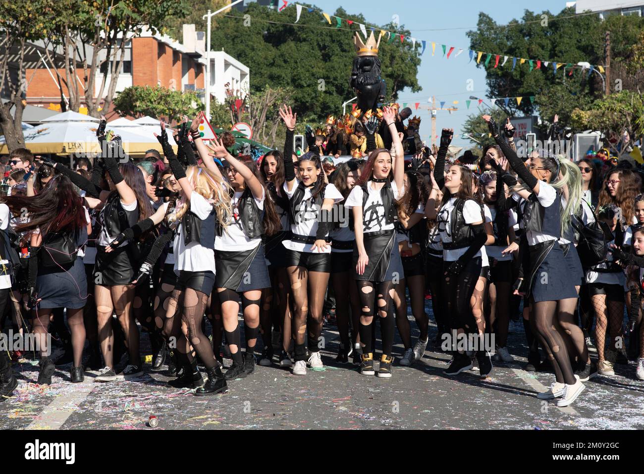Happy people in teams dressed with colourful costumes parading at ...