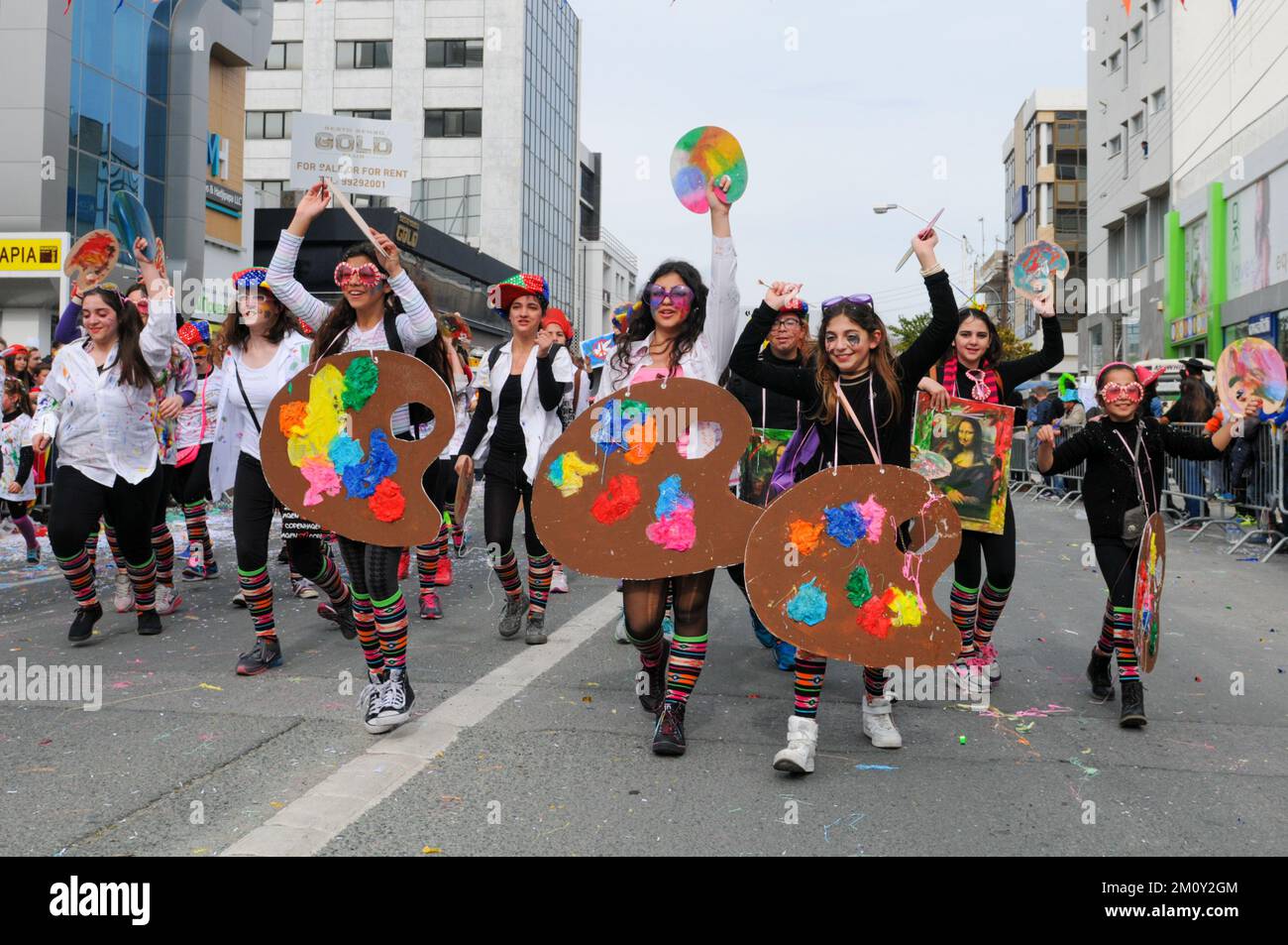 Happy people in teams dressed with colourful costumes parading at ...