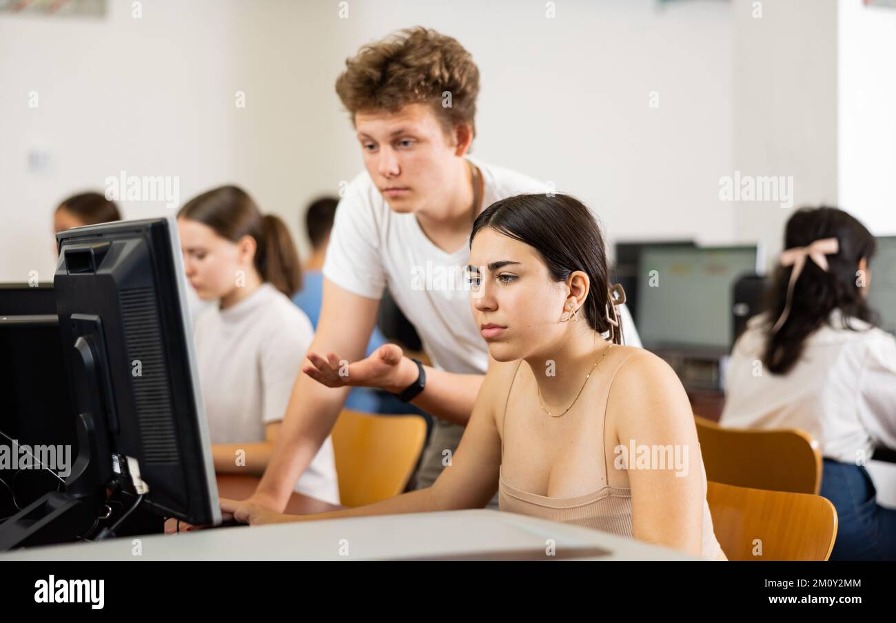 Teenagers using computer during computer science lesson Stock Photo - Alamy