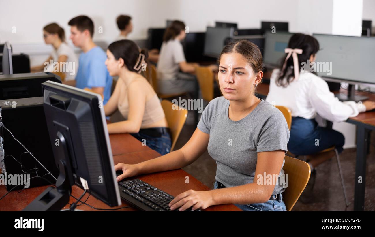 Female teacher working on computer in school class Stock Photo - Alamy
