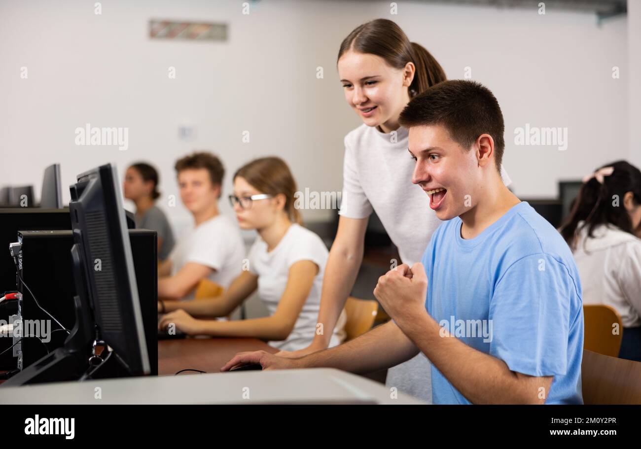 Clever students rejoicing solution of the task while using PC in the ...