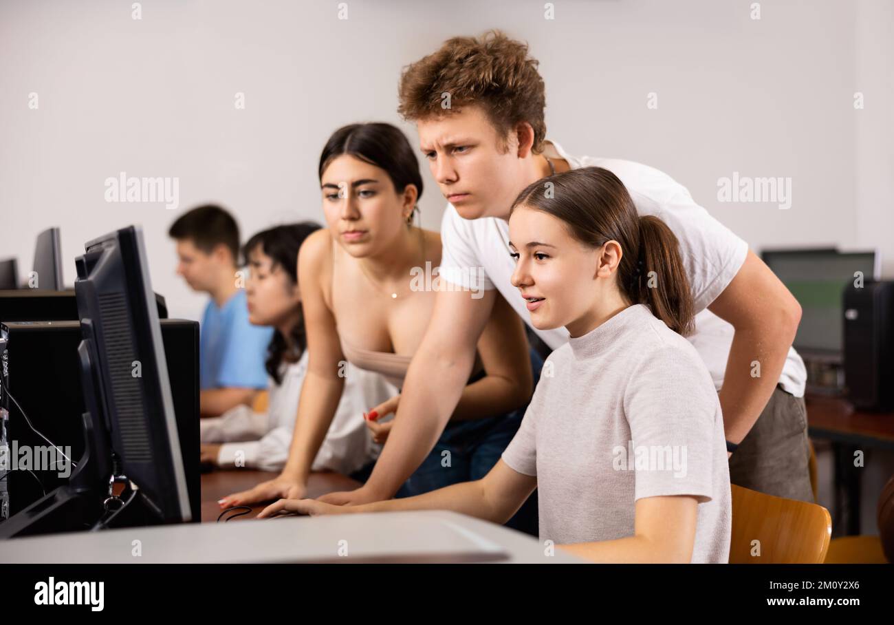 Portrait of female and male students working on computers in class Stock Photo - Alamy