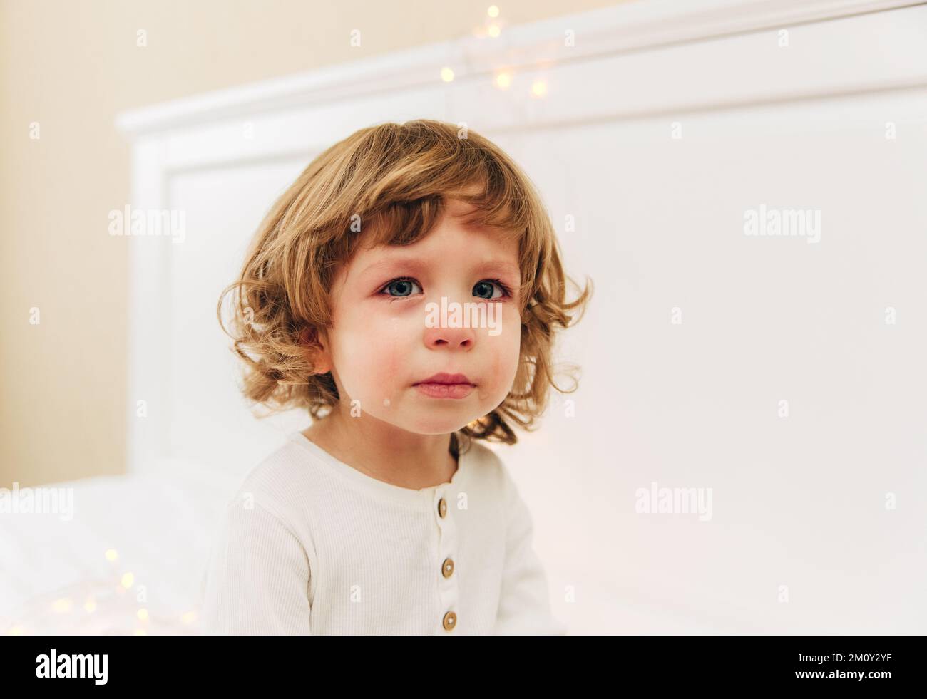 Portrait of tearful little girl.Small cute girl is crying.indoor.curly ...