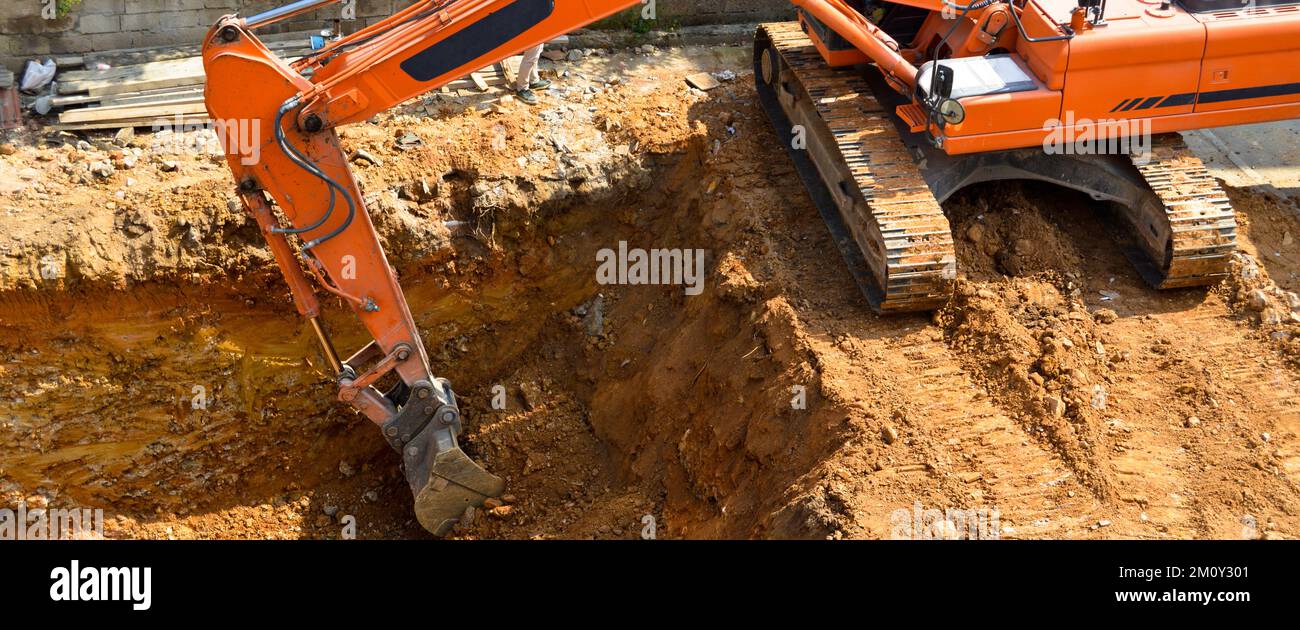 Excavator continues to work at the construction site, excavation site ...